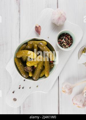 Preserving pickled cucumbers, pepper, seasonings and garlic on white ...
