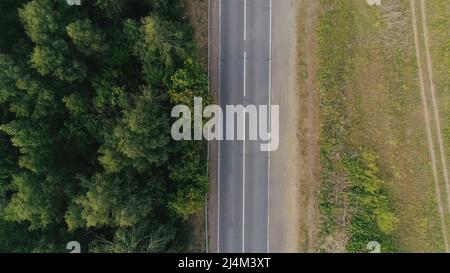 Top view of dividing line of forests and fields. Scene. Cars are ...