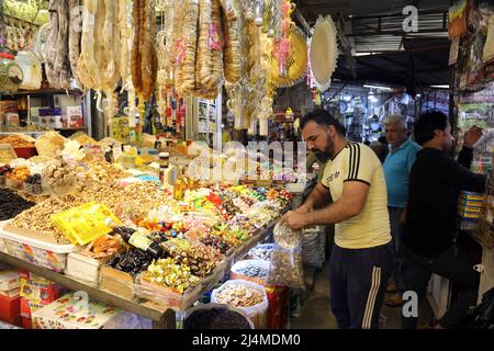 Baghdad, Iraq. 16th Apr, 2022. A shop owner displays his goods during ...