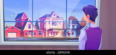 Man looking at window at autumn landscape of city street in rain ...