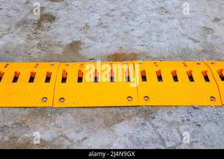 One way yellow traffic spikes at parking lot exit Stock Photo - Alamy