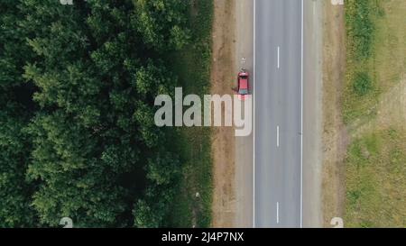 Top view of dividing line of forests and fields. Scene. Cars are ...