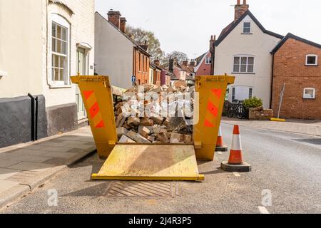 A builders skip containing rubble and bricks from a ongoing home ...