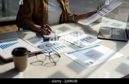 Close up of business woman or accountant working on calculator to ...