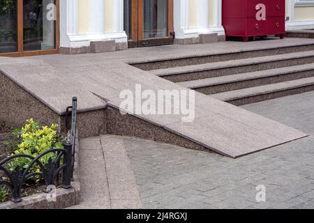 Ramped access, using wheelchair ramp for disabled people. Granite ramp ...