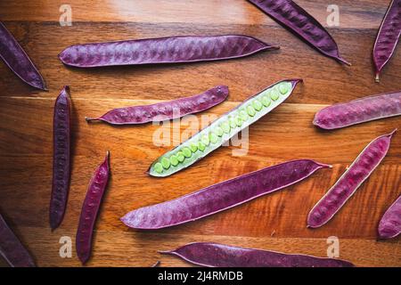 Guaje seed pods scattered on a wood table in a pattern Stock Photo - Alamy
