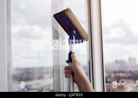 Washing window with special mop and cleaning services - housework and ...