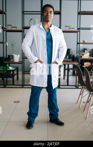 Handsome black doctor therapist and nurse working on blue background ...