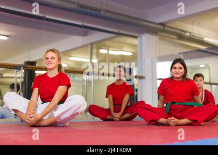 Karate kids and trainer sitting in lotus pose Stock Photo - Alamy