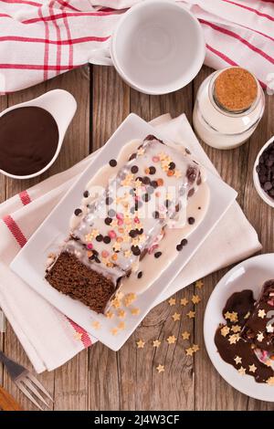 Sponge cake with white frosting and sugars Stock Photo - Alamy