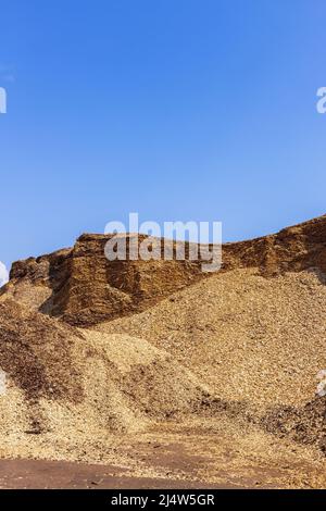 Storage of wood chips in piles for drying Stock Photo - Alamy