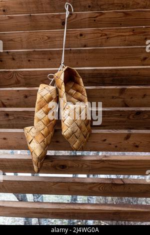 Vintage. Bast bast shoes hang on a wooden board Stock Photo - Alamy
