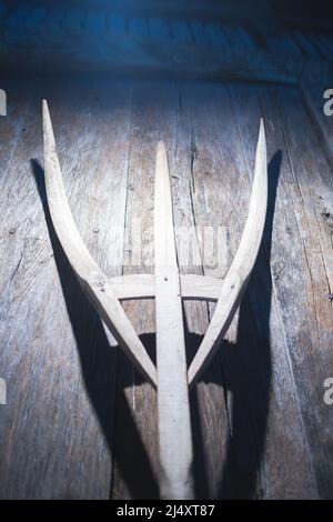 antique wooden pitchfork leaning on blue barn door Stock Photo - Alamy