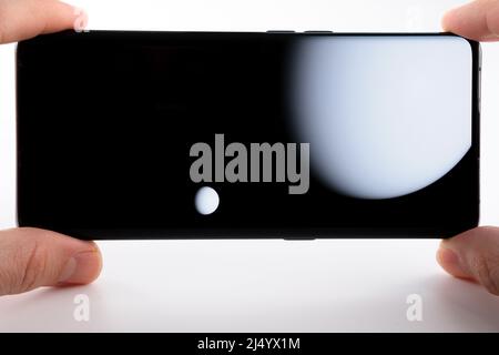 Smartphone with the NFT Merge digital art by Murat Pak. The most ...