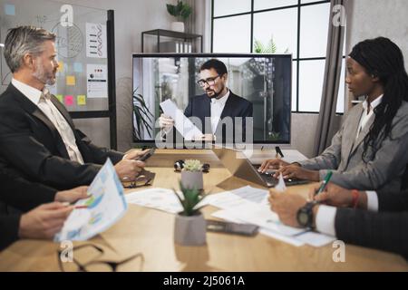 Group of four skillful multiethnical businesspeople clapping hands and ...