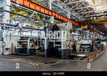 Workers and industrial machinery at metalworking factory production ...