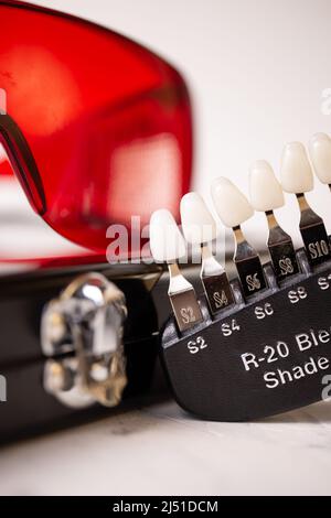 a scale for checking the color of teeth in close-up. Cosmetic dentistry ...