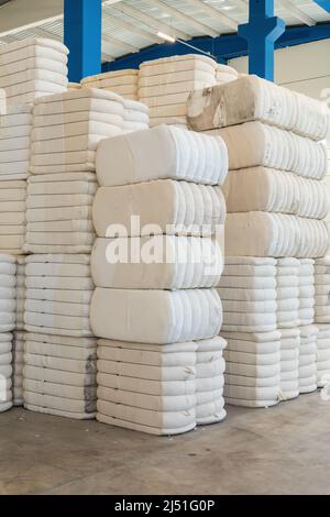 Pile or stack of cotton bales at textile factory or industry Stock ...