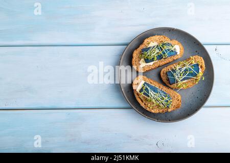 Bread sandwiches with blue lavender cheese and mustard microgreen on ...