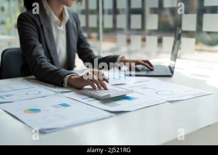 Close up of business woman or accountant working on calculator to ...