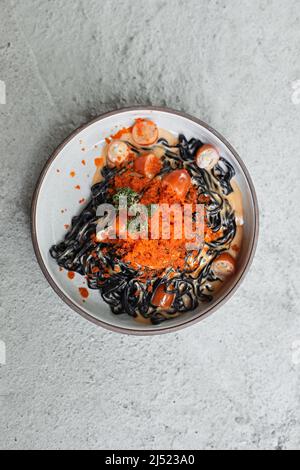 Black spaghetti cream sauce with ebiko Stock Photo - Alamy