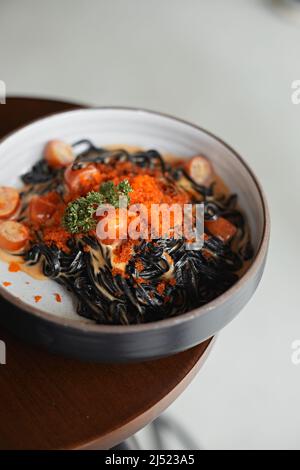 Black spaghetti cream sauce with ebiko Stock Photo - Alamy