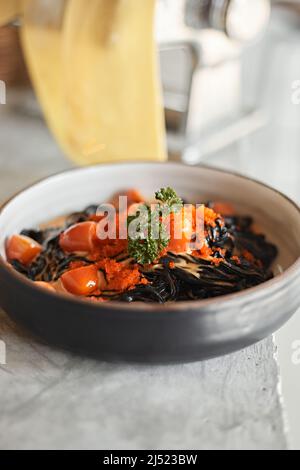 Black spaghetti cream sauce with ebiko Stock Photo - Alamy