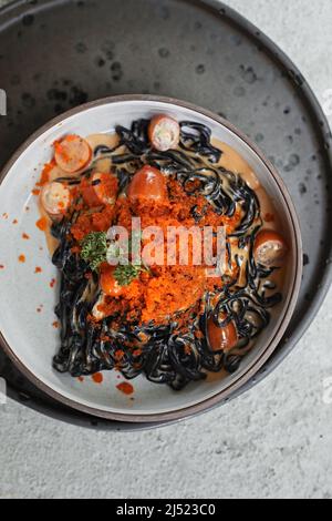 Black spaghetti cream sauce with ebiko Stock Photo - Alamy