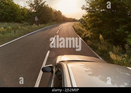 Gray vehicle travelling on a sunny mountain road Stock Photo - Alamy