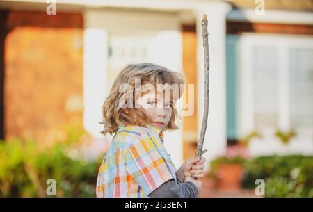 Child aggression concept. Negative kids emotion. Angry boy with stick ...
