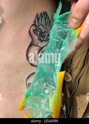 man removing protective foil from a freshly inked tattoo Stock Photo ...