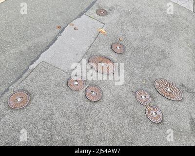 various street caps for hydrants and gate valves on the pavement ...