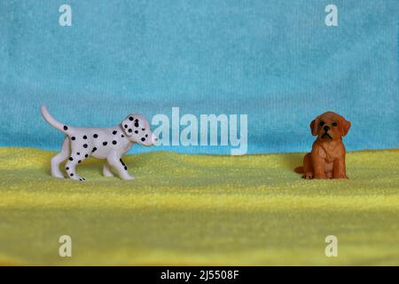 Model plastic dogs on a dishcloth beach Stock Photo - Alamy