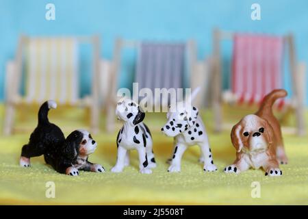 Model plastic dogs on a dishcloth beach Stock Photo - Alamy