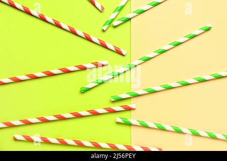 Stylish straws for drinks on green background Stock Photo - Alamy