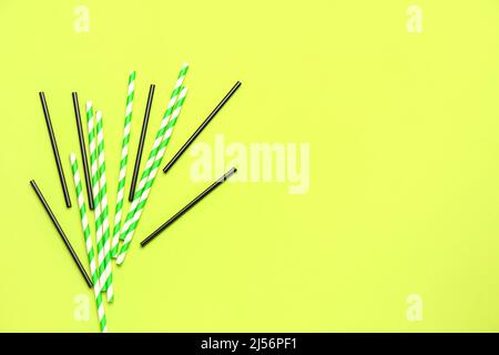 Stylish straws for drinks on green wooden background Stock Photo - Alamy