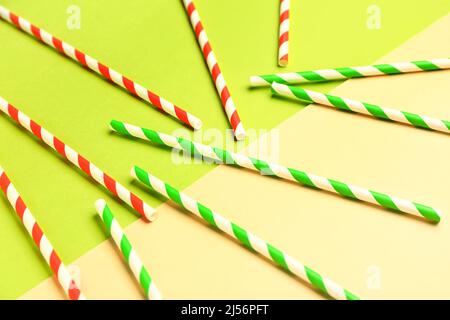 Stylish straws for drinks on green wooden background Stock Photo - Alamy