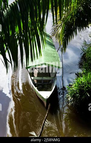 Boat stopped on the river among the trees. Nilo Pecanha, Bahia, Brazil ...