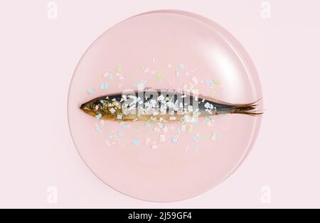 Fish covered microplastic on a pink plate. Impact of micro plastic on ...