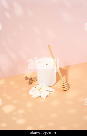 Organic scented soy candle in dark glass jar on ceramic tray ...