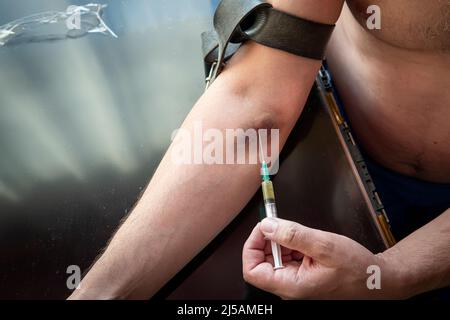 Man drugs addicted injecting heroine in his arm. Drugs concept. Disease ...