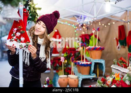 Female near counter with Christmas gifts Stock Photo - Alamy