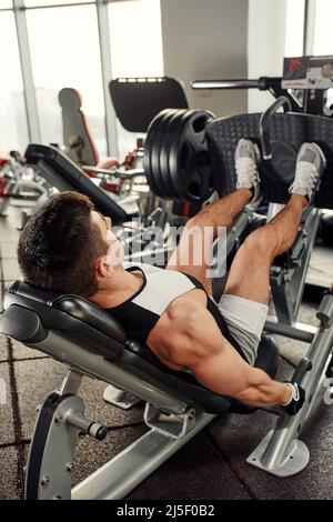 Determined athletic man works out at the gym with a barbell Stock Photo ...
