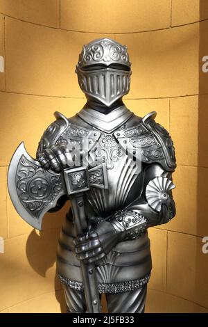 A sculpture of a soldier in a suit of armour with a dragon at his feet ...