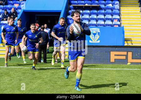Toby King #4 of Warrington Wolves leads the Warrington Wolves players ...