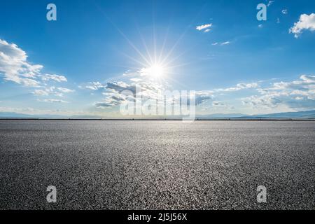 Asphalt road platform and beautiful blue sky with white clouds scene ...