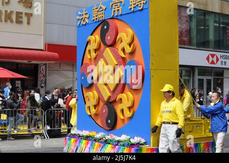 A carnival float with Falun Gong symbols is being pushed down the Main ...