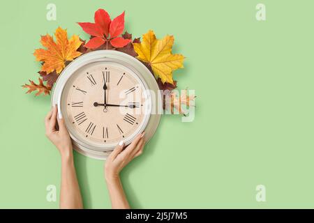Woman with clock in autumn, wintertime Stock Photo - Alamy