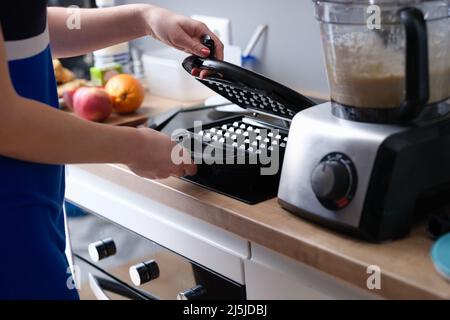 Woman opens electric waffle maker for Viennese and Belgian waffles ...