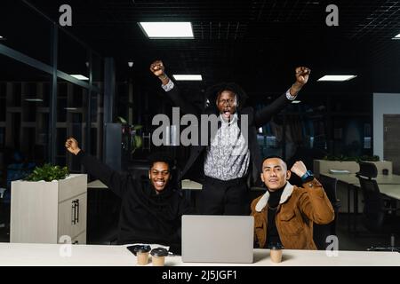 Teambuilding black Africans and Asians. Positive mixed race colleagues ...